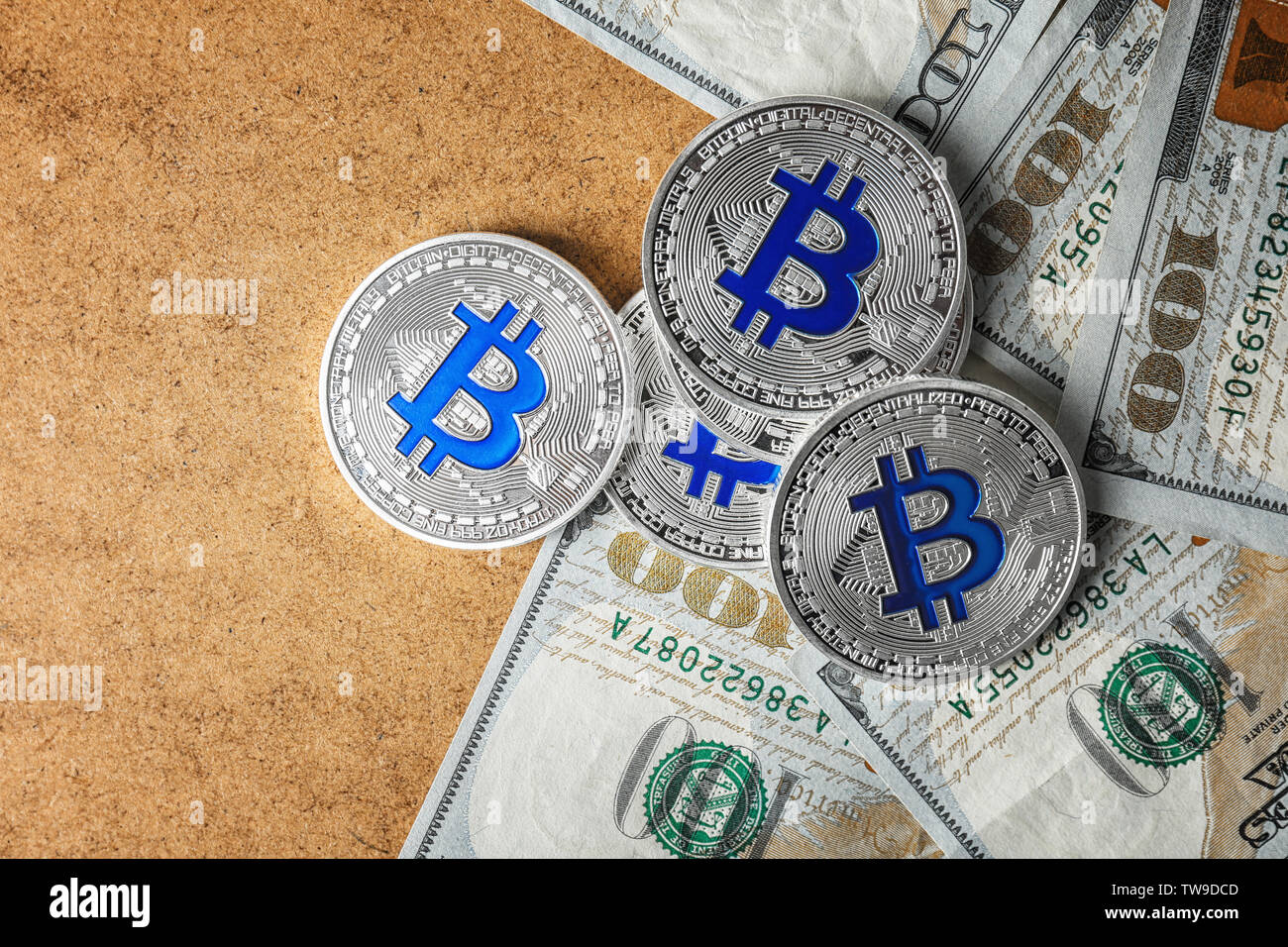 Silver bitcoins with dollar bills on color background Stock Photo - Alamy