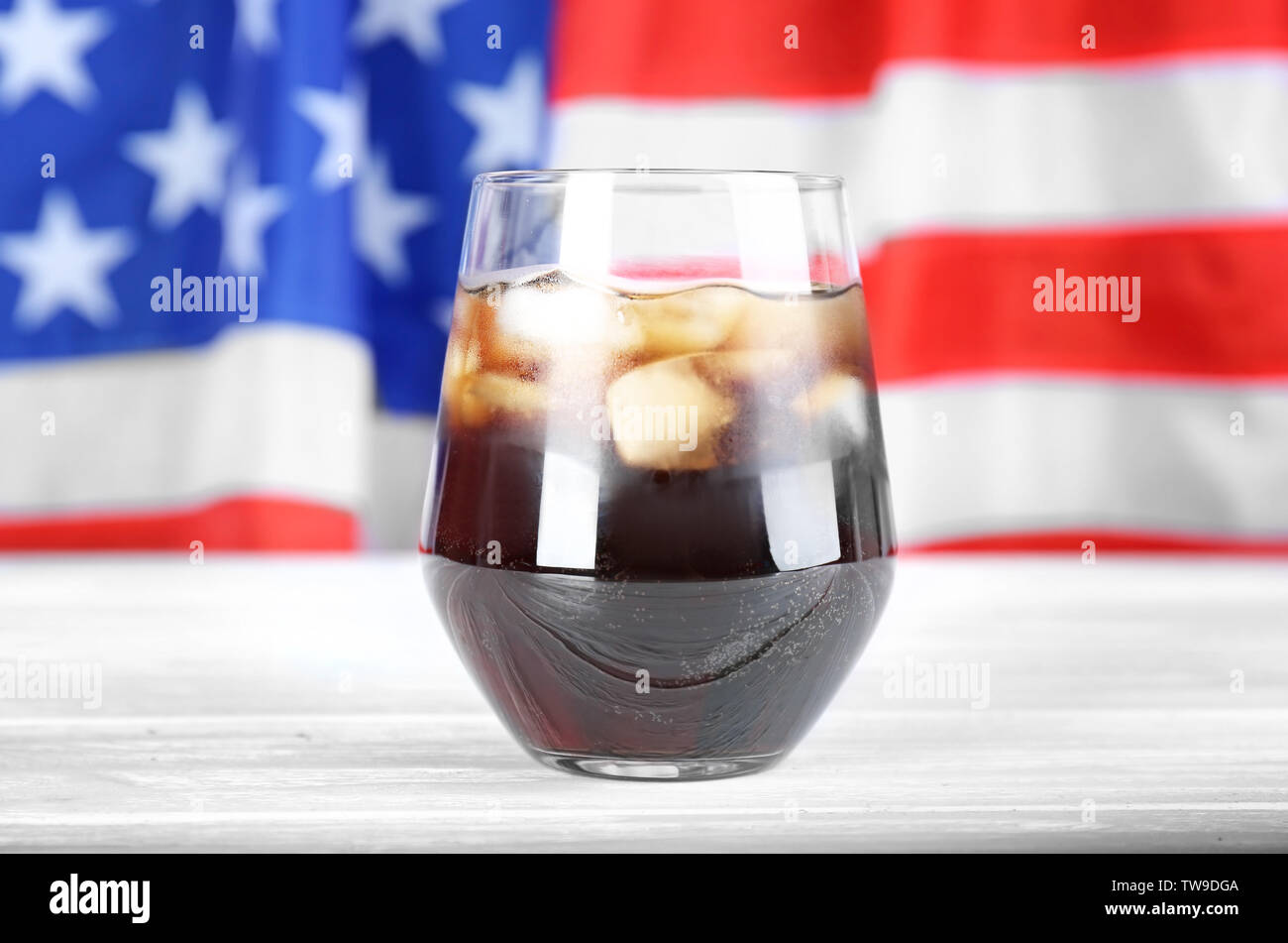 Glass of cold cola on table against flag of the USA Stock Photo - Alamy