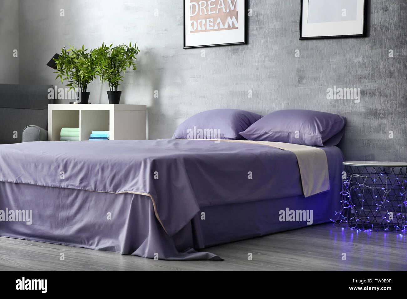Cozy room interior with comfortable bed Stock Photo - Alamy