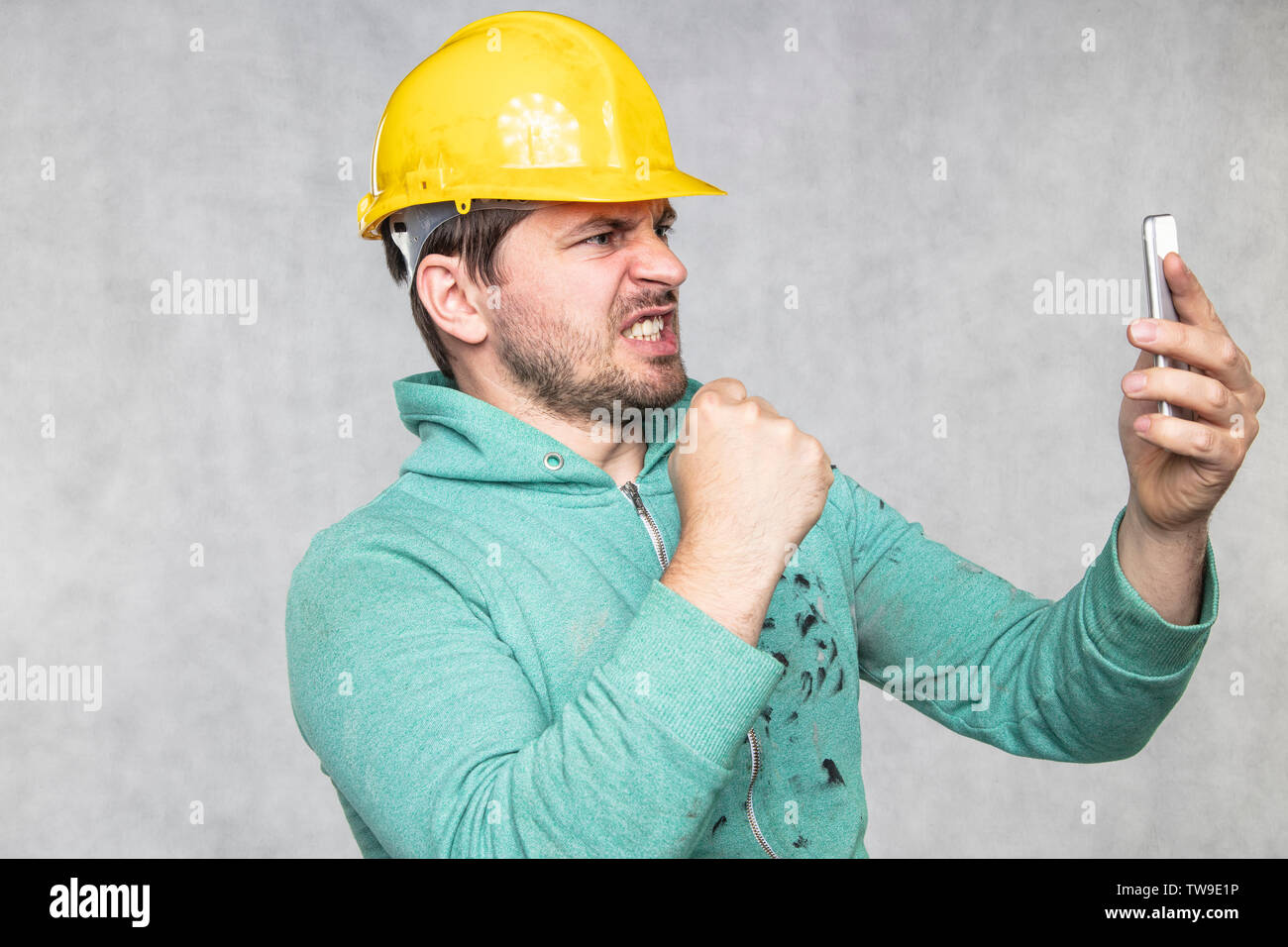 The building supervisor is shouting to a cell phone, side view Stock ...