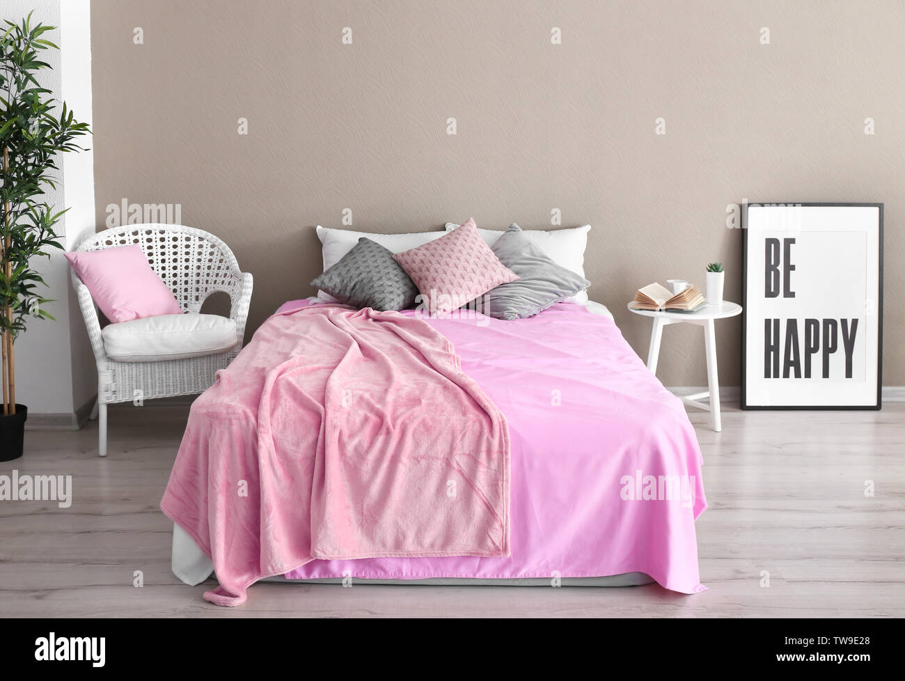 Cozy room interior with comfortable bed Stock Photo - Alamy