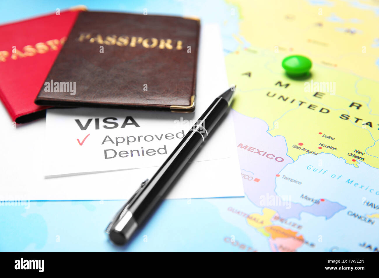 Passports and pen on map. Approved American visa Stock Photo - Alamy