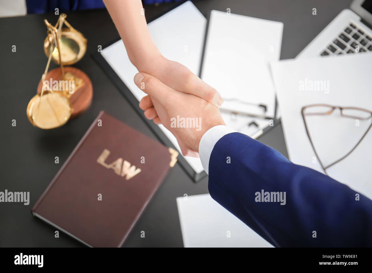 Lawyer shaking hands with client in office, closeup Stock Photo - Alamy