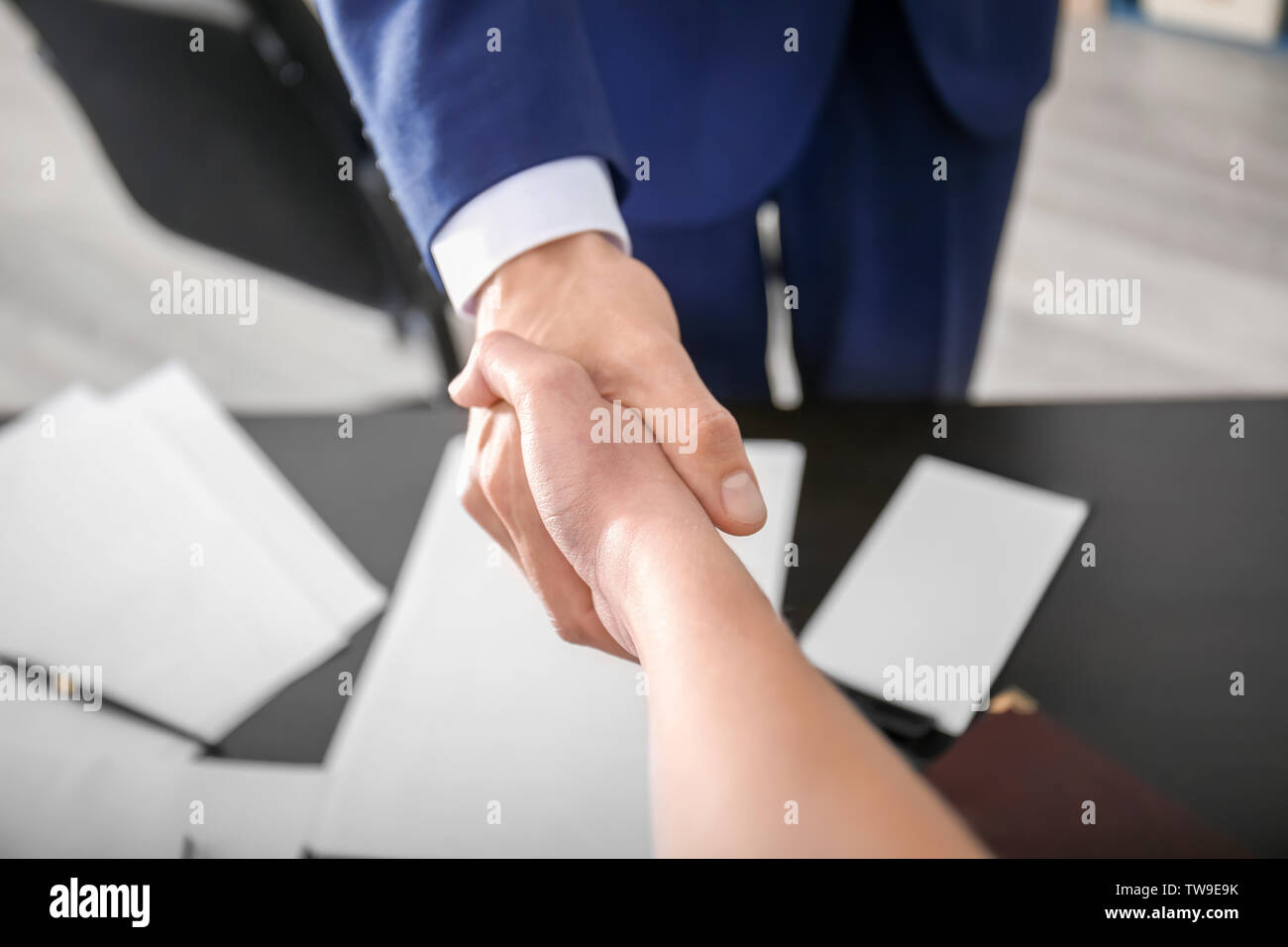 Lawyer shaking hands with client in office, closeup Stock Photo - Alamy