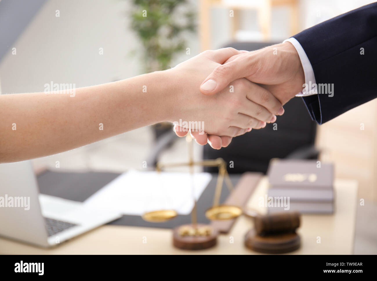 Lawyer shaking hands with client in office, closeup Stock Photo - Alamy