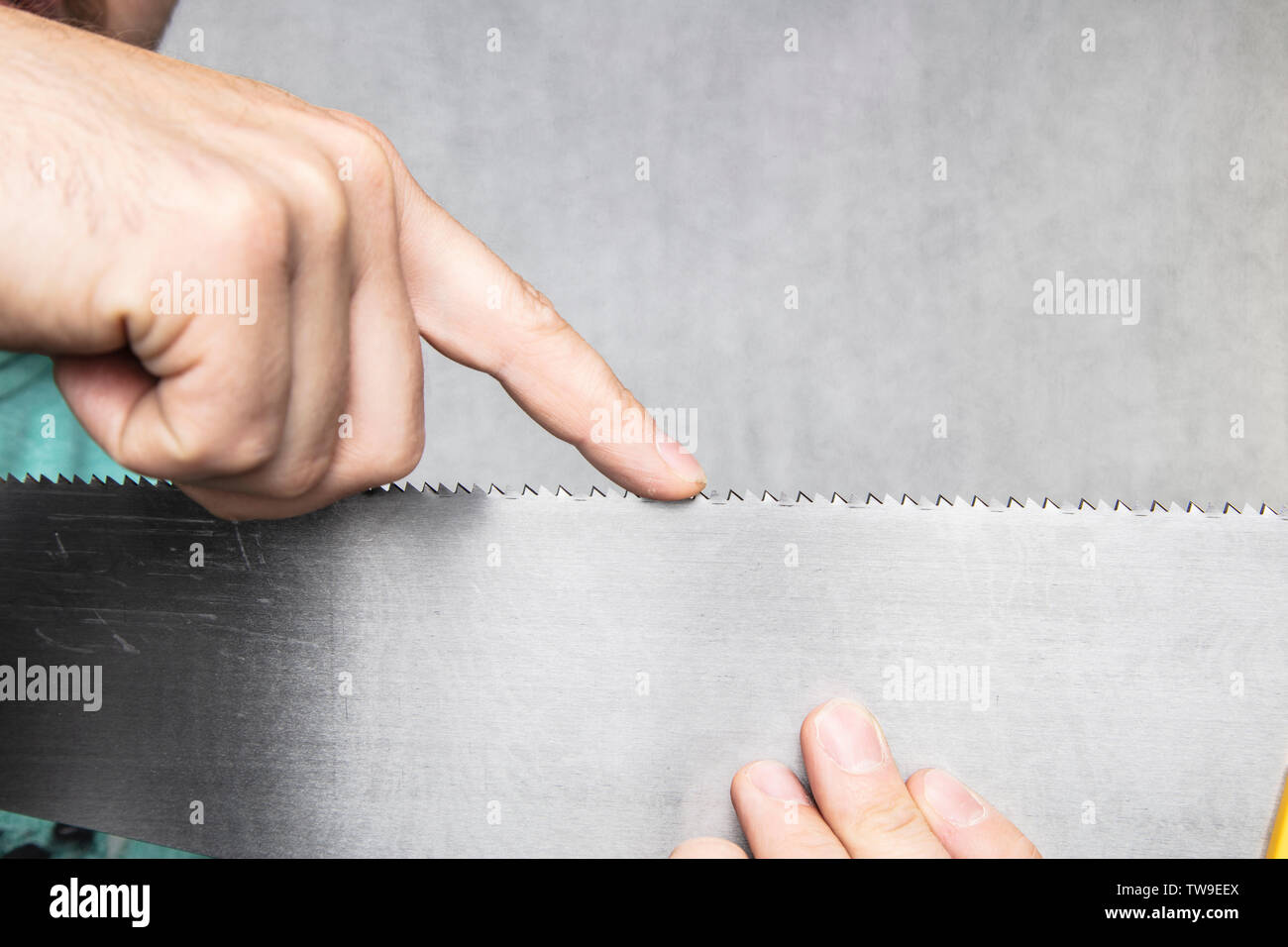 the construction worker shows how sharp the cutting saw is Stock Photo ...