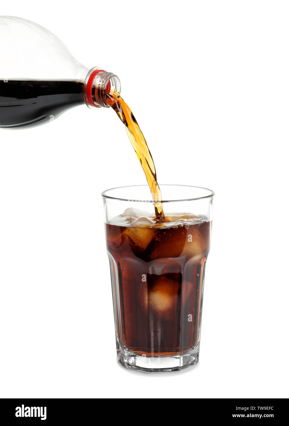 Cola pouring from bottle into glass with ice on white background Stock ...