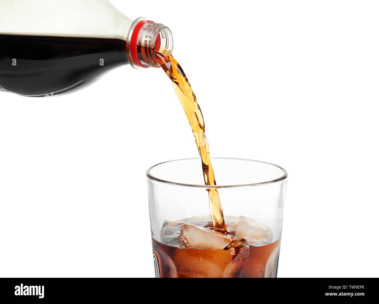 Cola pouring from bottle into glass with ice on white background Stock ...