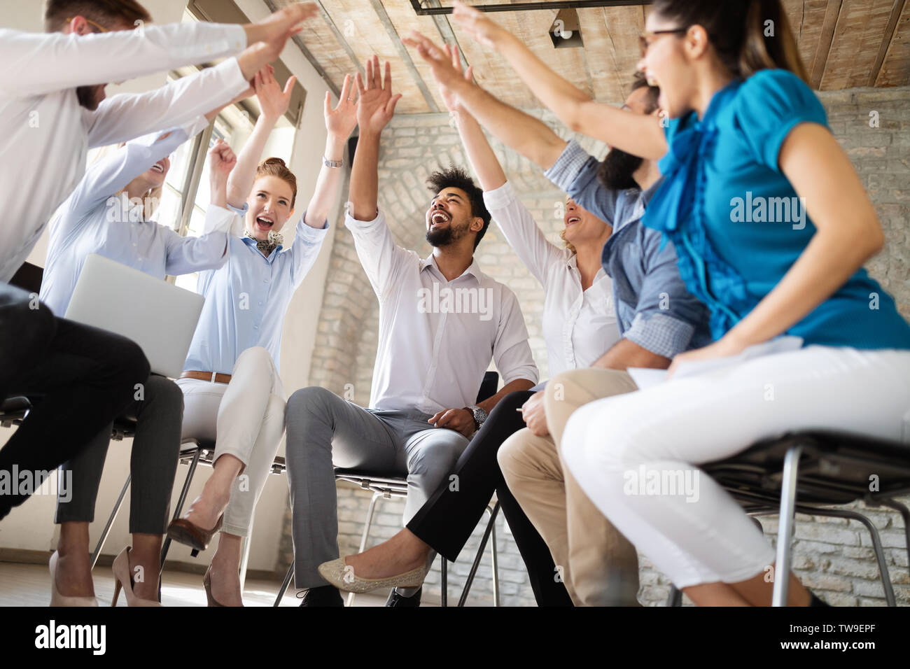 Business team celebrating a good job in the office Stock Photo - Alamy