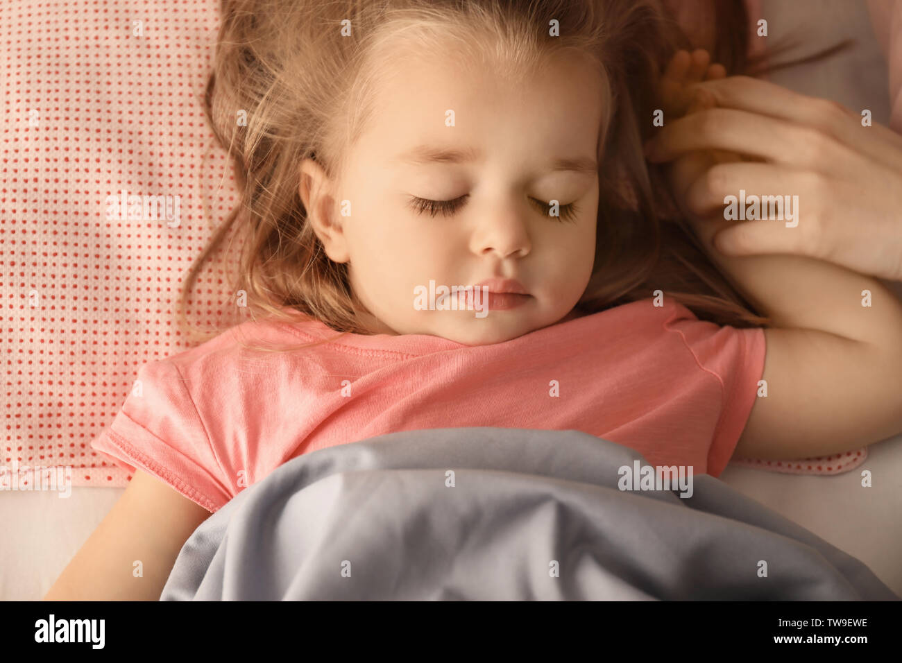 Cute little girl sleeping in bed at home Stock Photo - Alamy