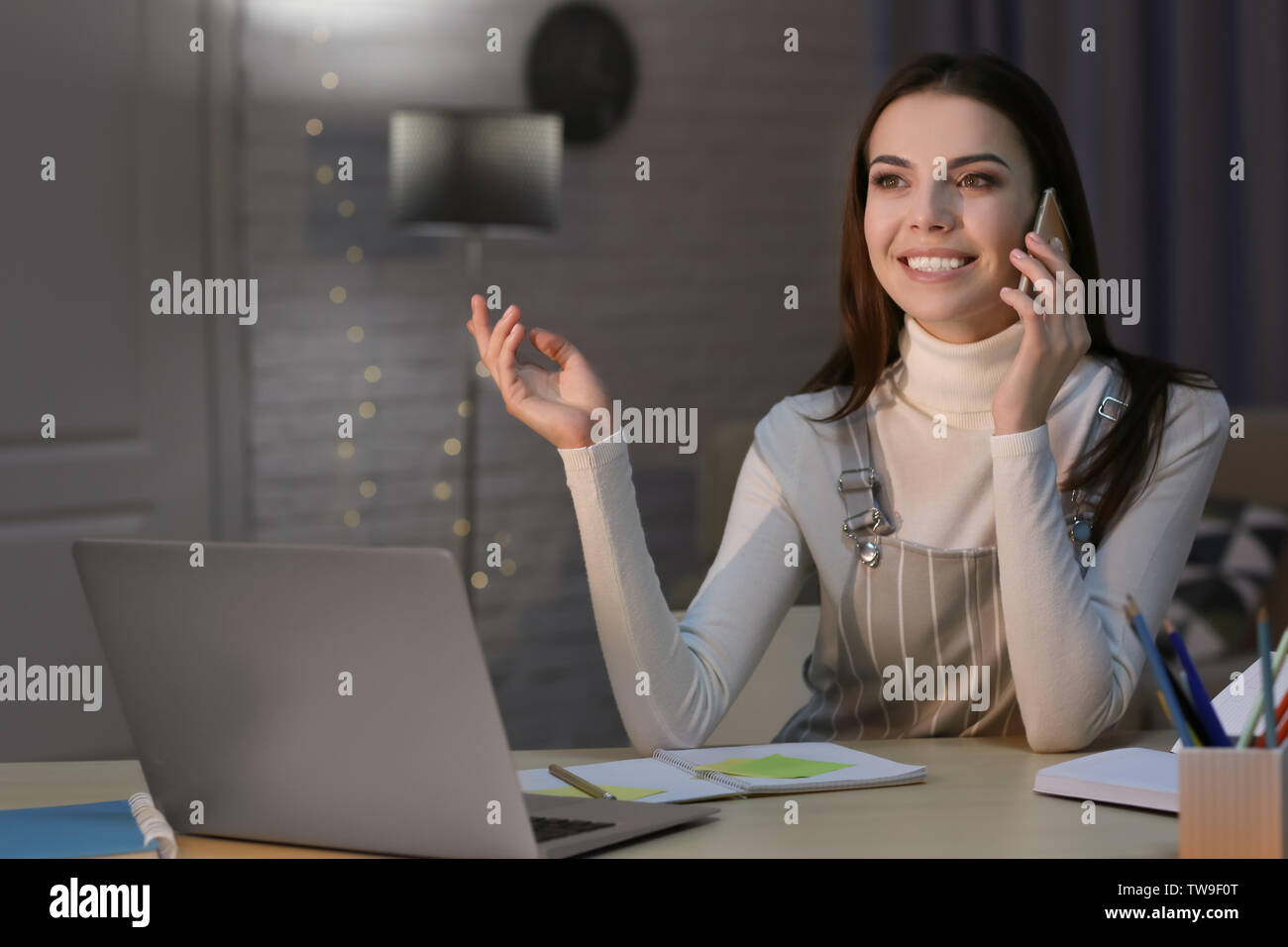 Young woman working late in home office Stock Photo - Alamy