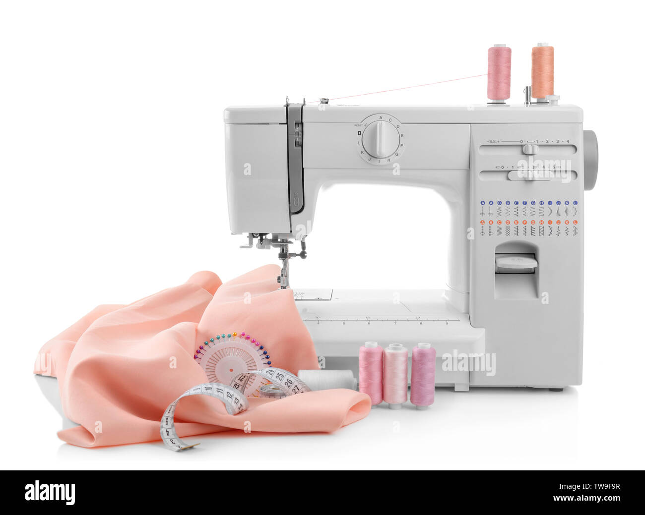Modern sewing machine with threads and fabric on white background Stock ...