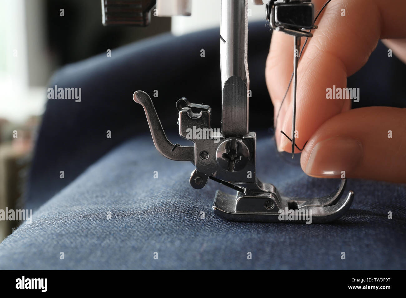 Woman using sewing machine, closeup Stock Photo - Alamy