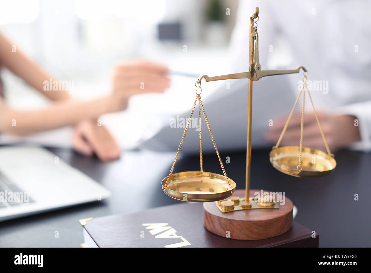 Scales of justice with juridical book on table in lawyer's office Stock ...