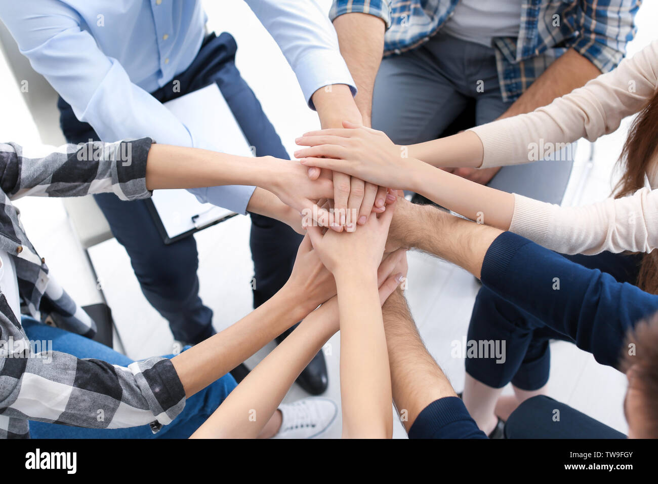 People putting their hands together at group therapy session Stock ...