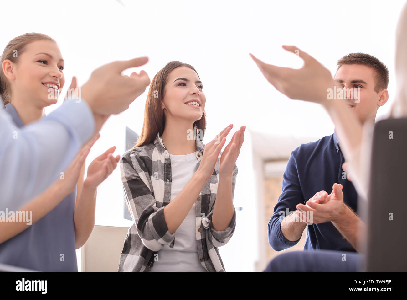 People clapping at group therapy session Stock Photo - Alamy