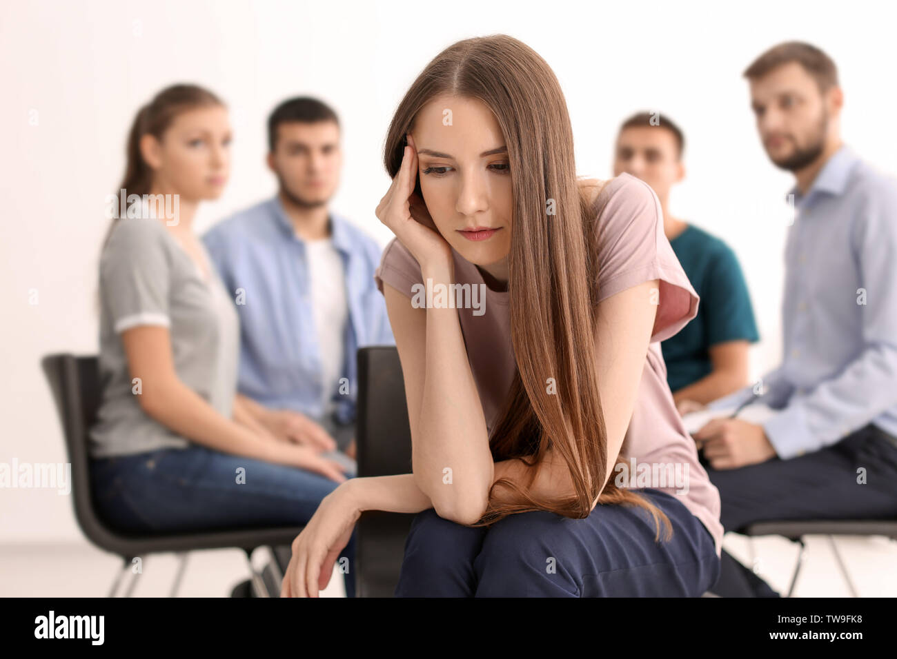 Sad young woman at group therapy session Stock Photo - Alamy