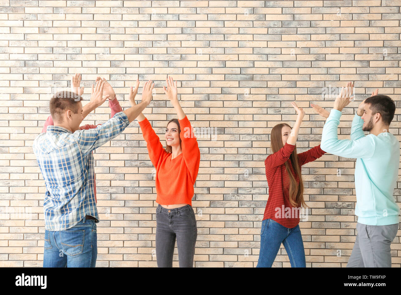 People giving high five, indoors. Unity concept Stock Photo - Alamy