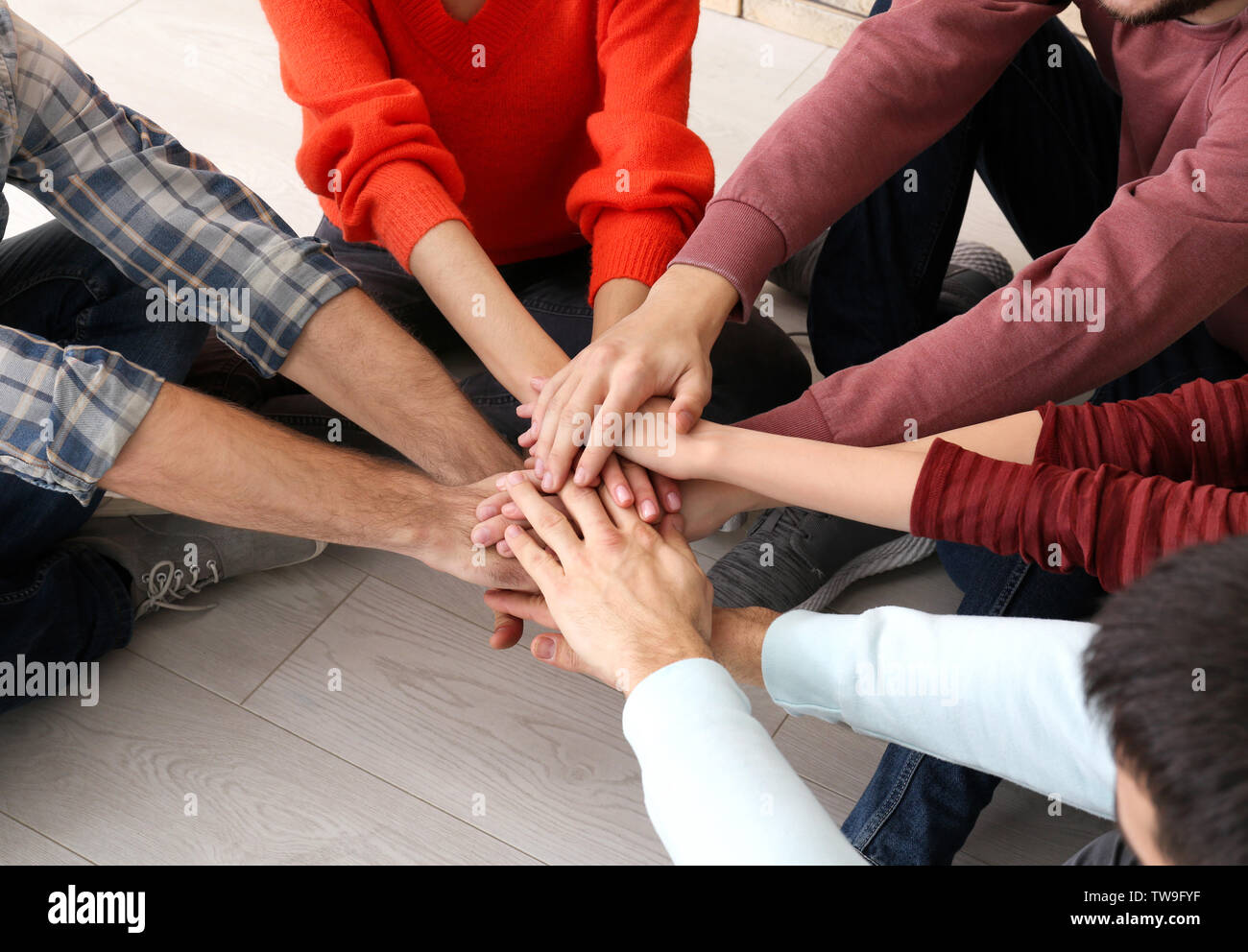 People putting hands together, closeup. Unity concept Stock Photo - Alamy