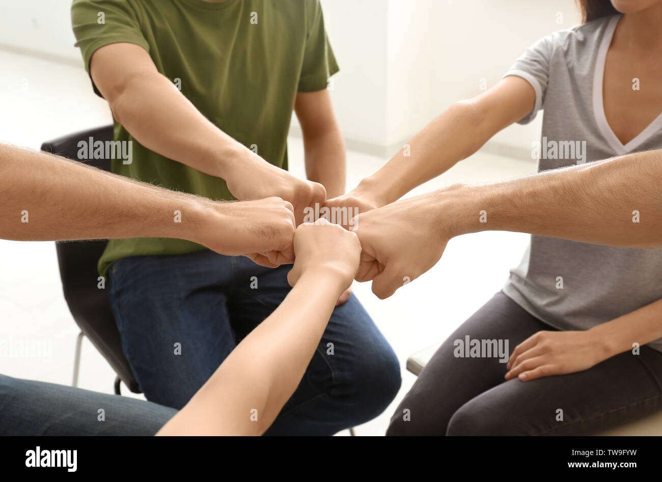 People putting fists together, closeup. Unity concept Stock Photo - Alamy