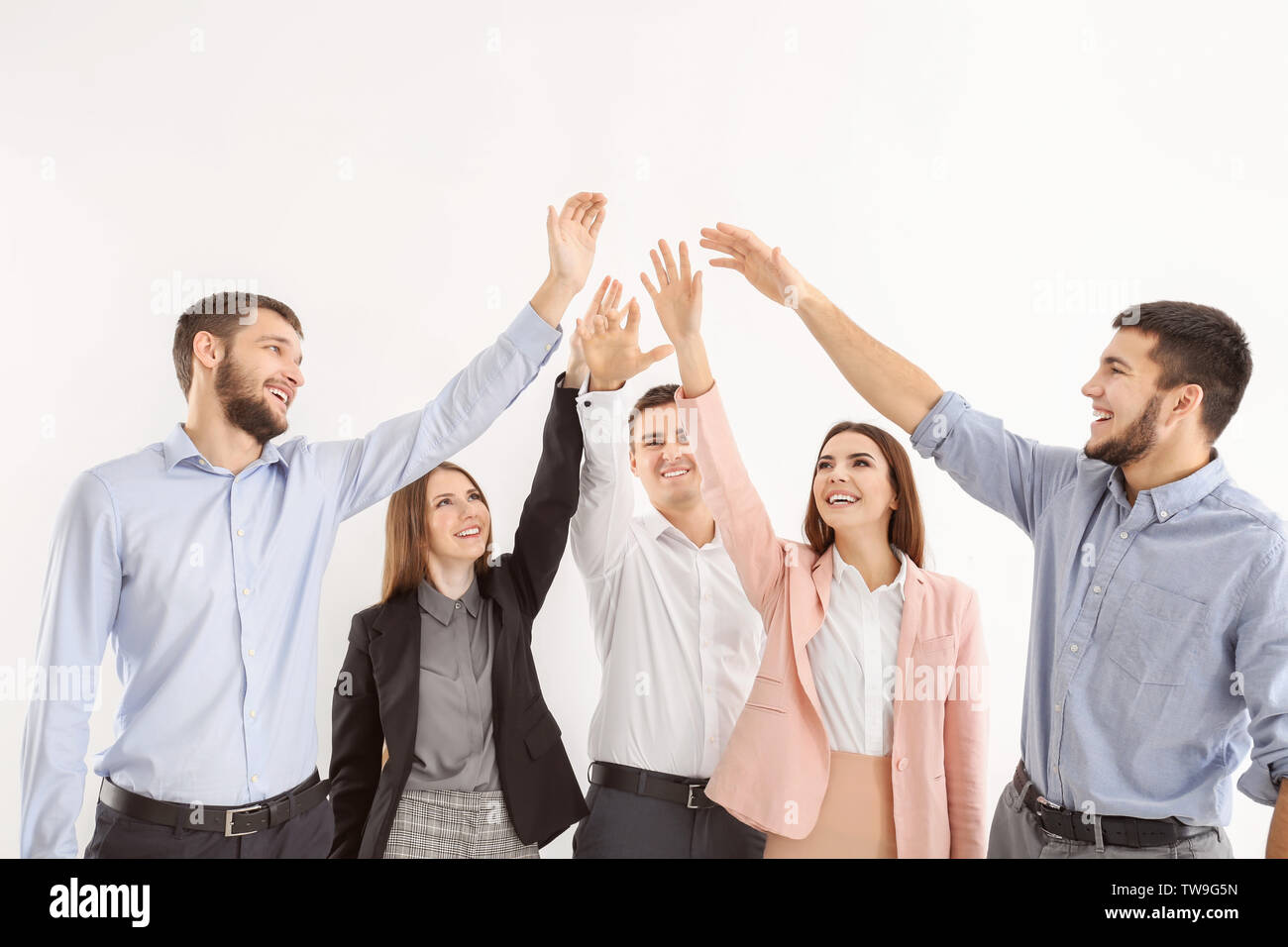Young people giving high five on white background. Unity concept Stock ...