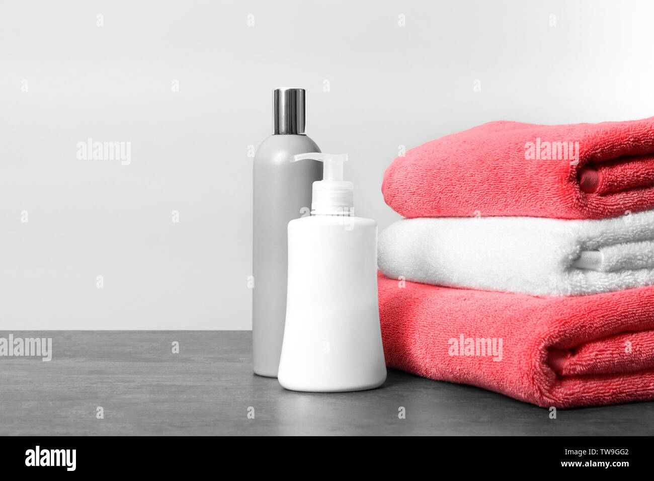 Clean towels and toiletries on table Stock Photo - Alamy