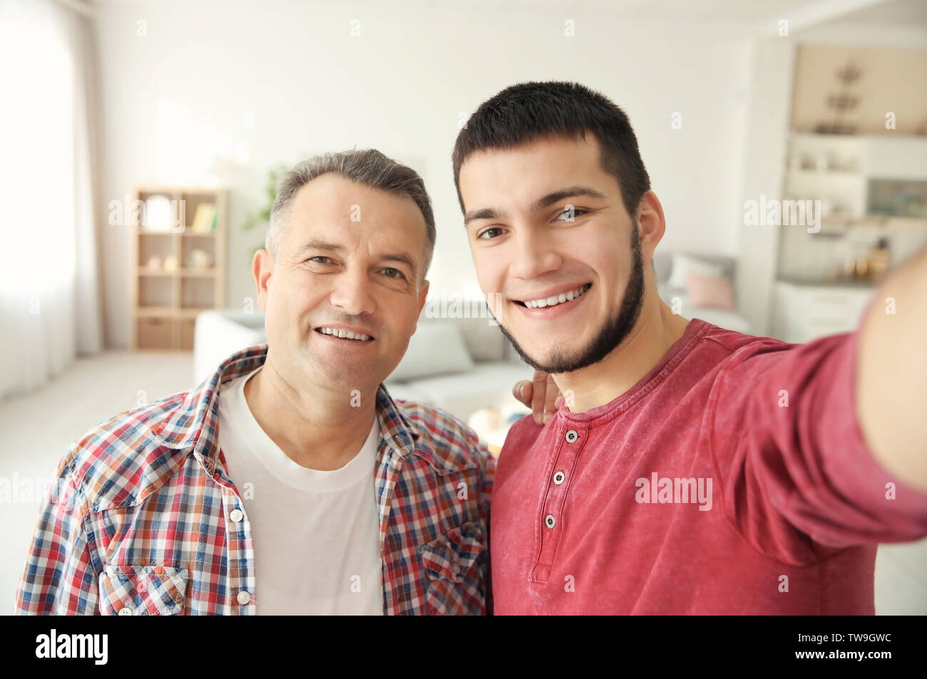 Young man and his dad at home Stock Photo - Alamy