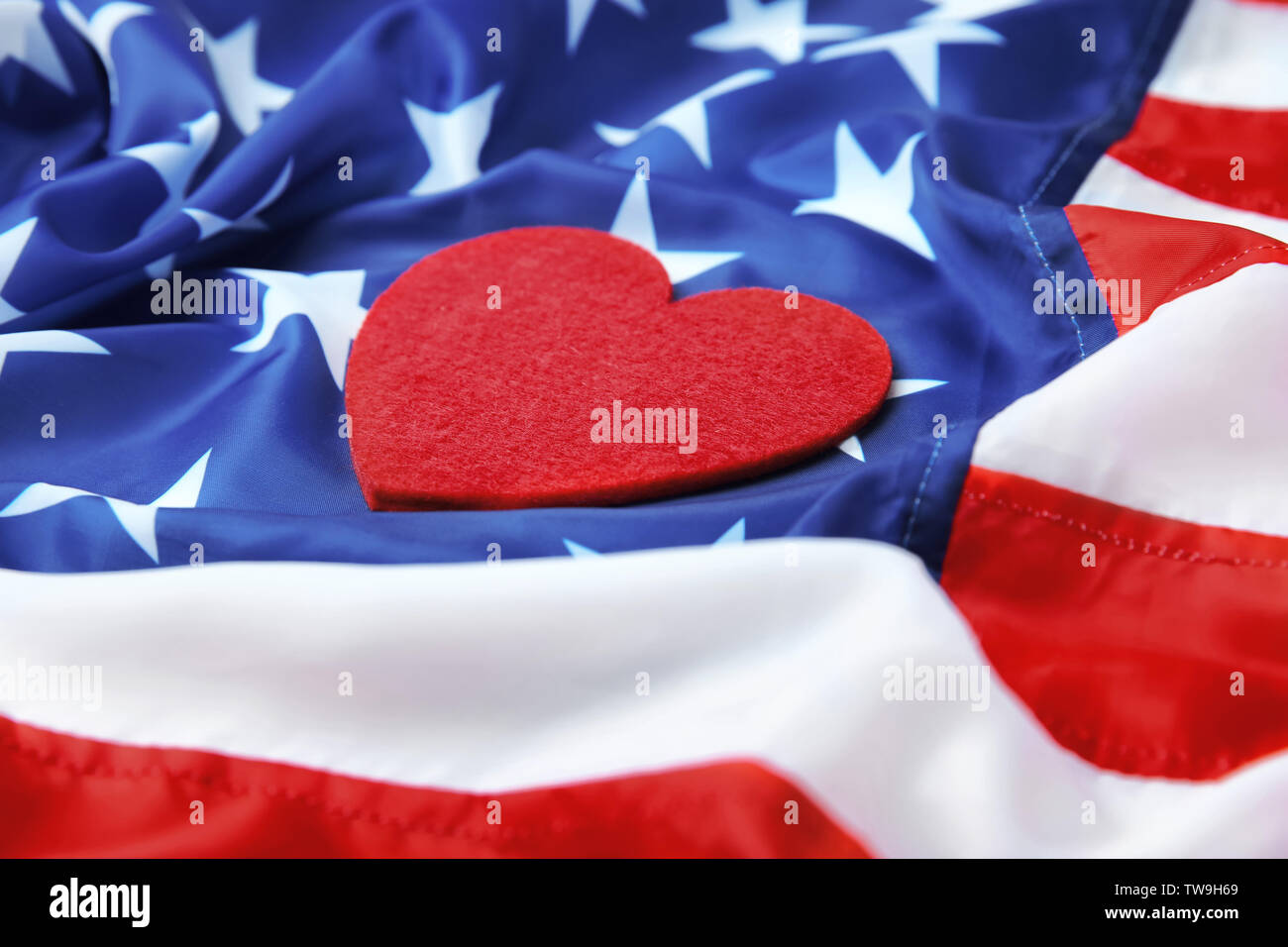 Red felt heart on American flag. USA holiday Stock Photo - Alamy