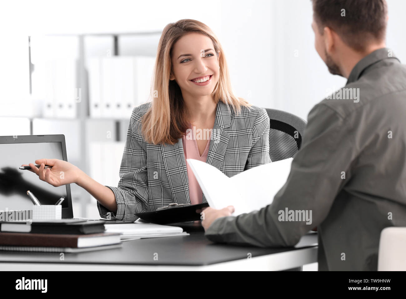 Consulting manager with man at meeting in office Stock Photo - Alamy