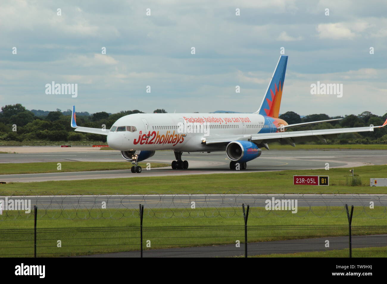 Families visiting Manchester airport's runway visitor park watching the ...