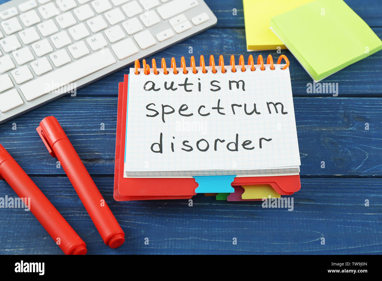 Notepad with text AUTISM SPECTRUM DISORDER on wooden background Stock ...