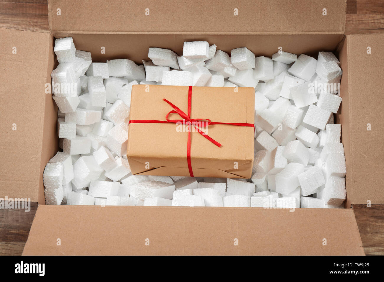 Gift box in parcel, top view Stock Photo - Alamy