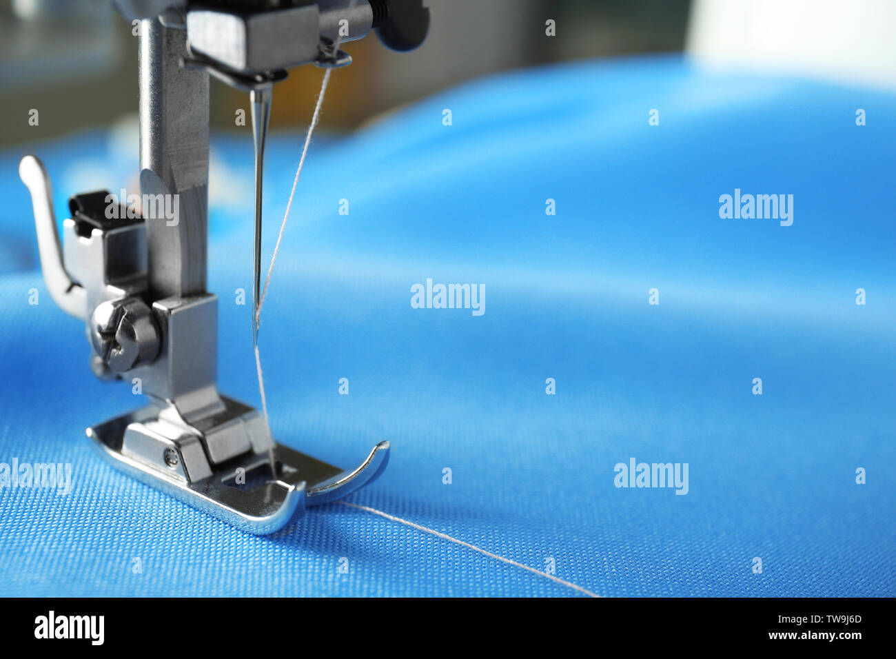 Sewing machine with fabric and thread, closeup Stock Photo - Alamy