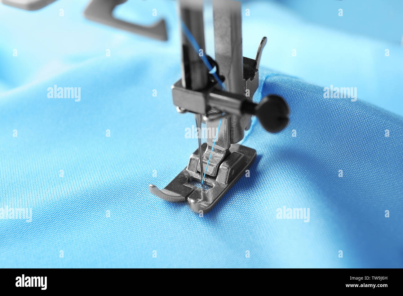 Sewing machine with fabric and thread, closeup Stock Photo - Alamy