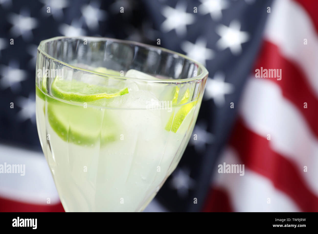 Glass with alcoholic cocktail on American flag background Stock Photo ...