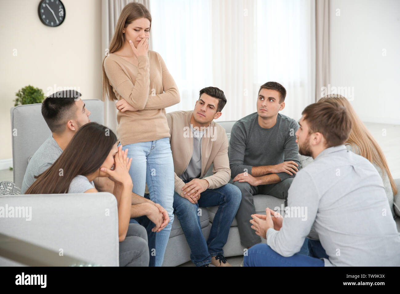 Young woman talking about her problems during group therapy Stock Photo ...
