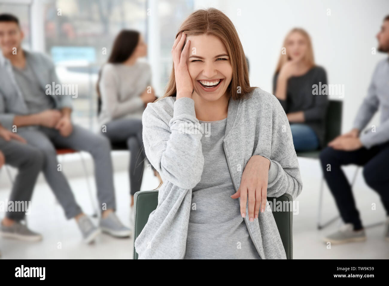 Laughing woman during group therapy, indoors Stock Photo - Alamy
