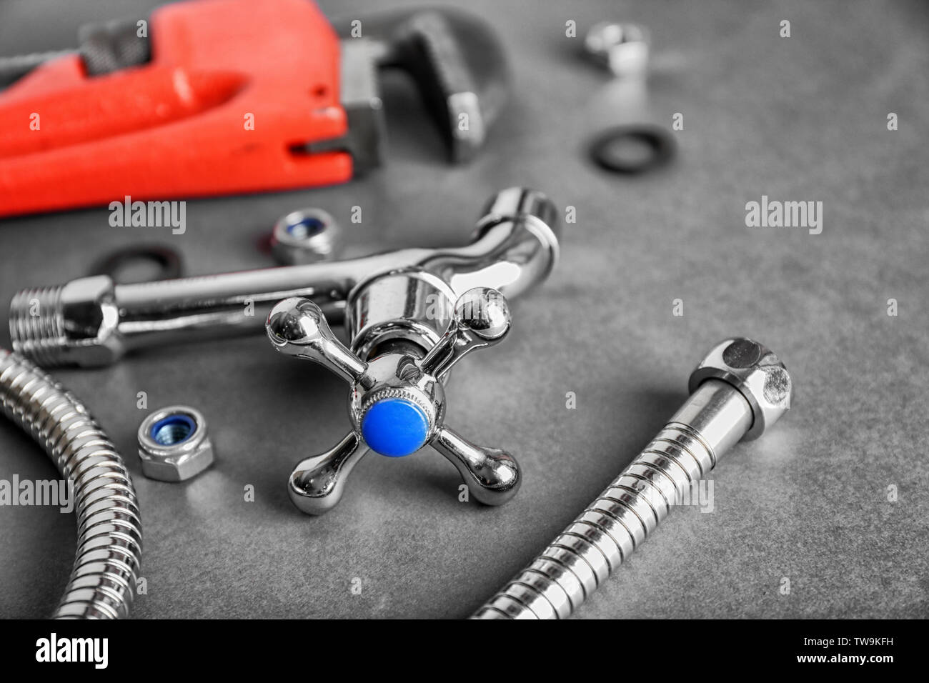 Plumber's items on grey background Stock Photo - Alamy