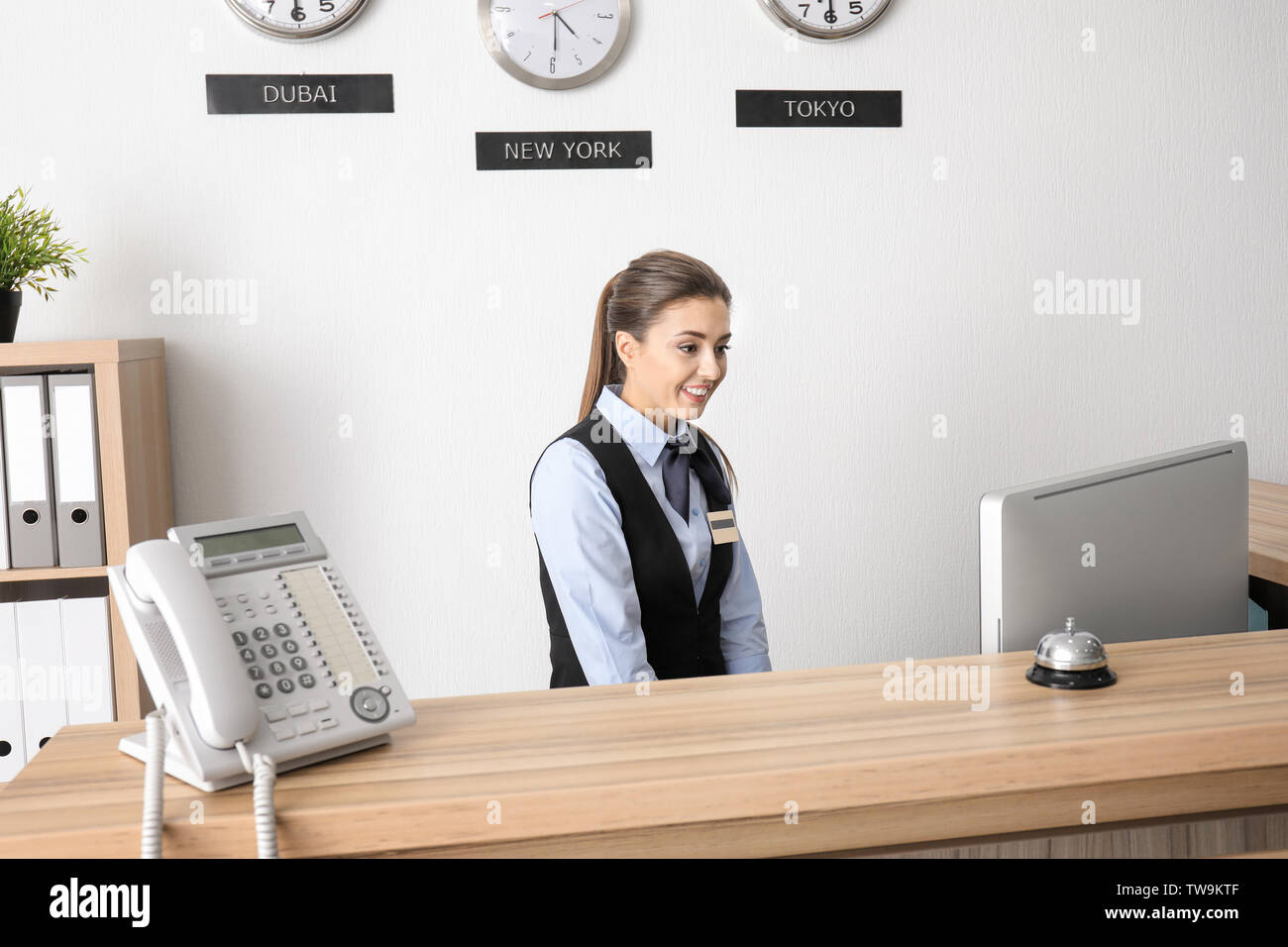 Female receptionist working in hotel Stock Photo - Alamy