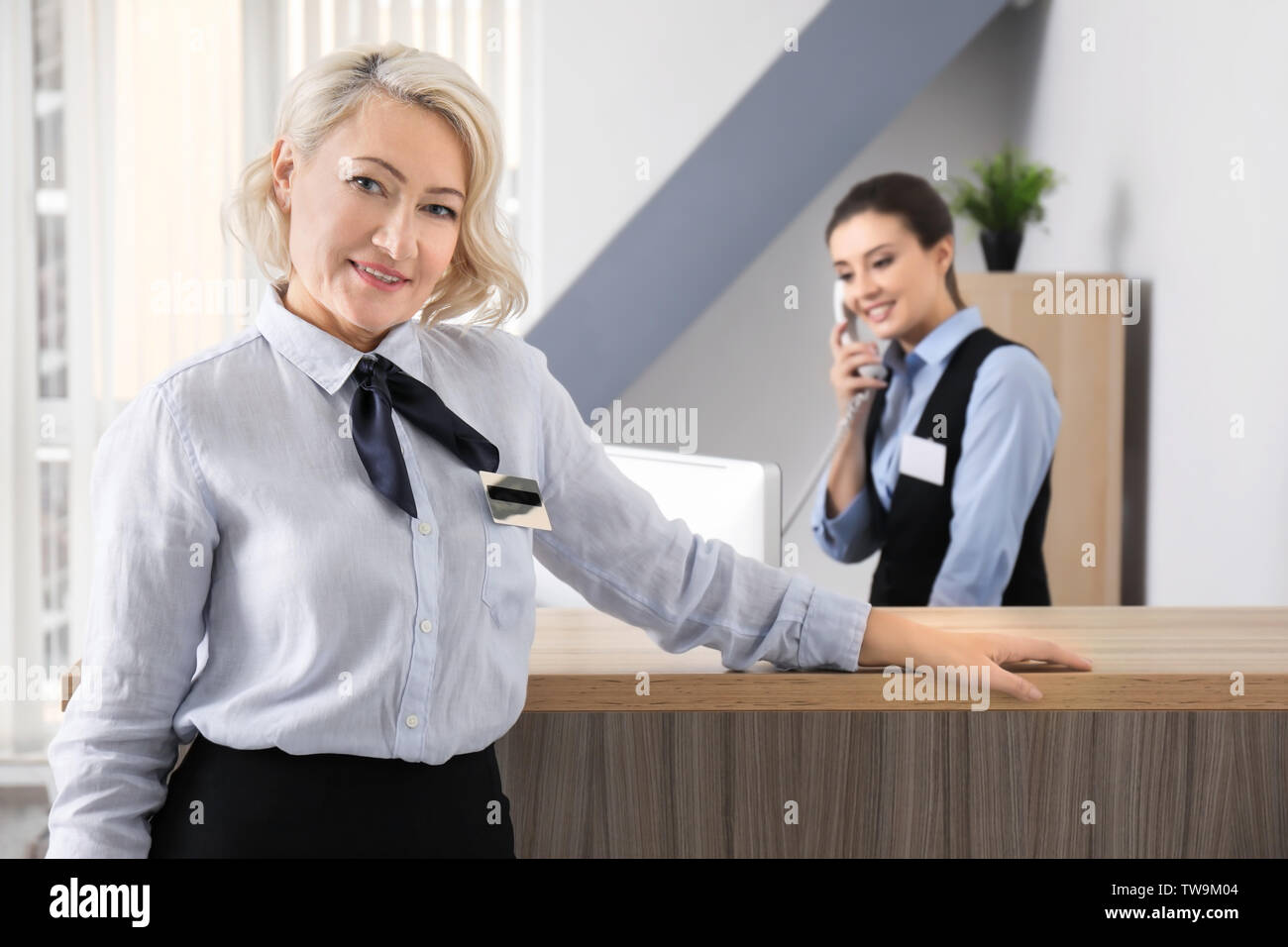 Female hotel receptionist at workplace Stock Photo - Alamy