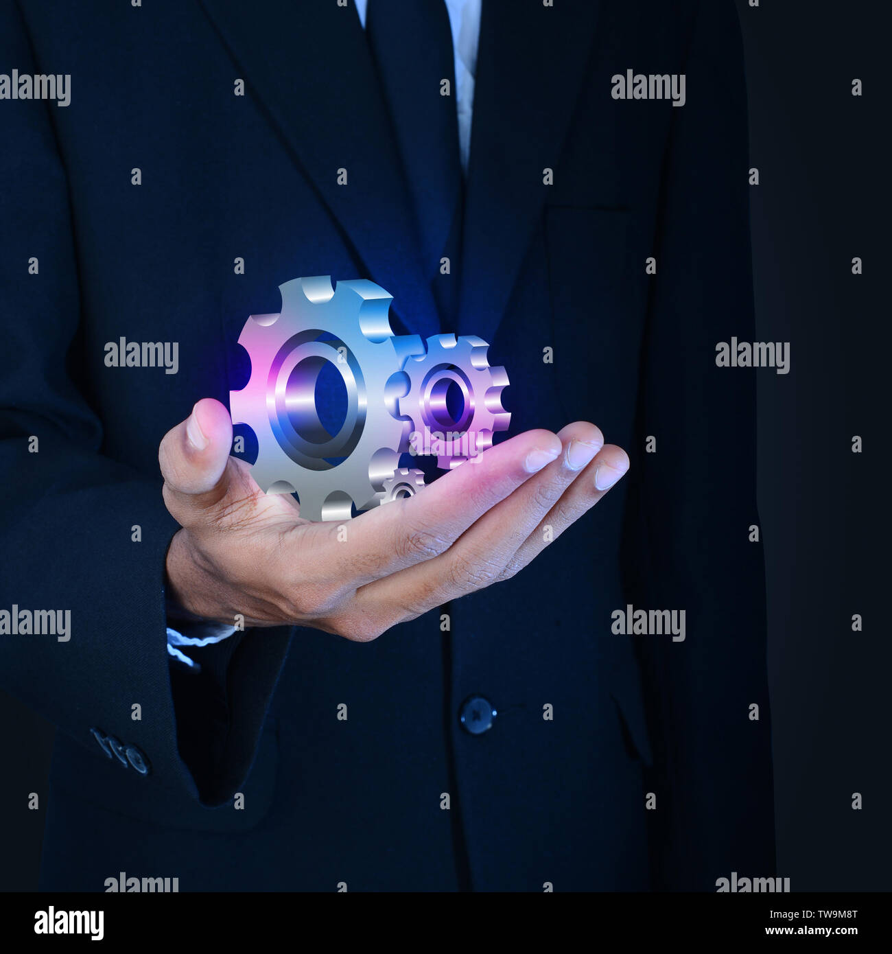 businessman showing gears cogs to success concept Stock Photo - Alamy