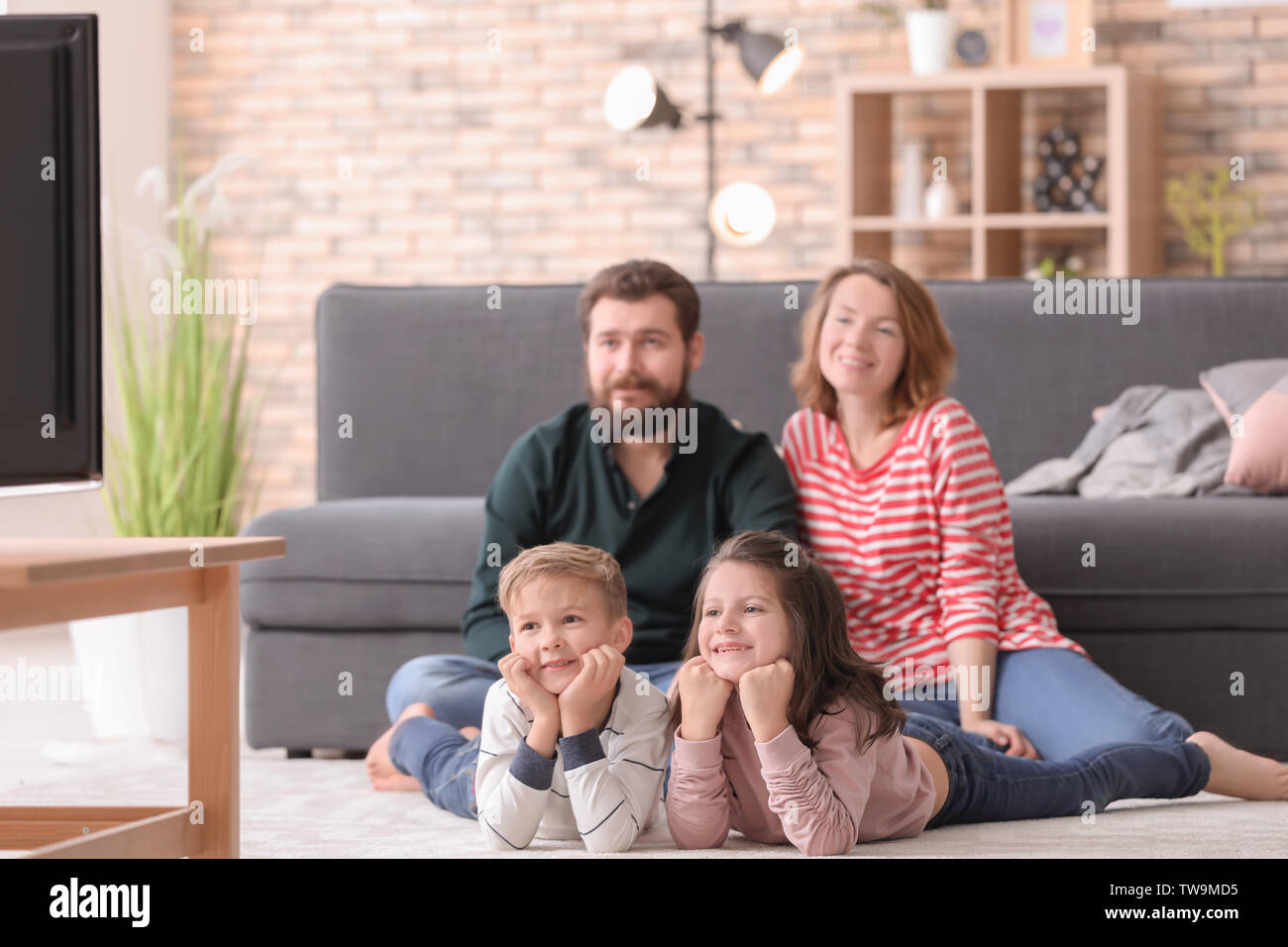 Happy family watching TV at home Stock Photo - Alamy