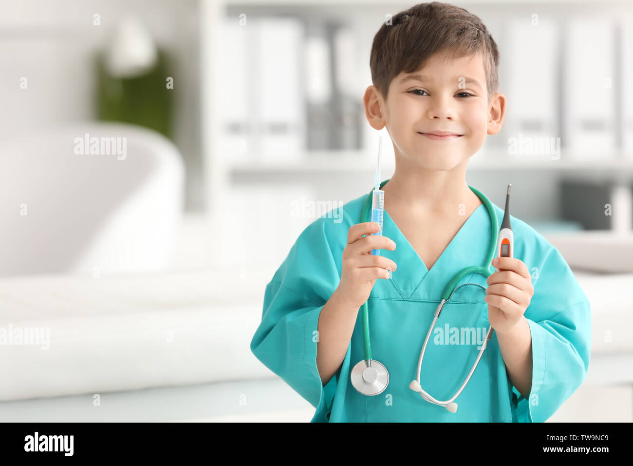Cute little boy in doctor uniform and with medical instruments in ...