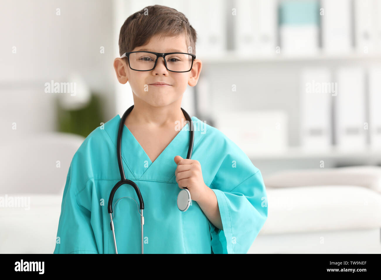 Cute little boy wearing doctor uniform in hospital Stock Photo - Alamy