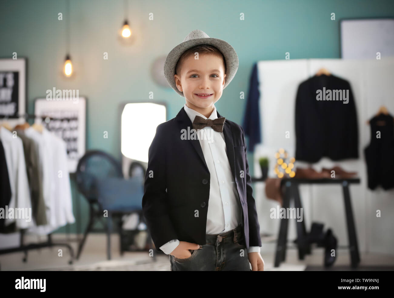 Cute boy in jacket with hat, indoors Stock Photo - Alamy