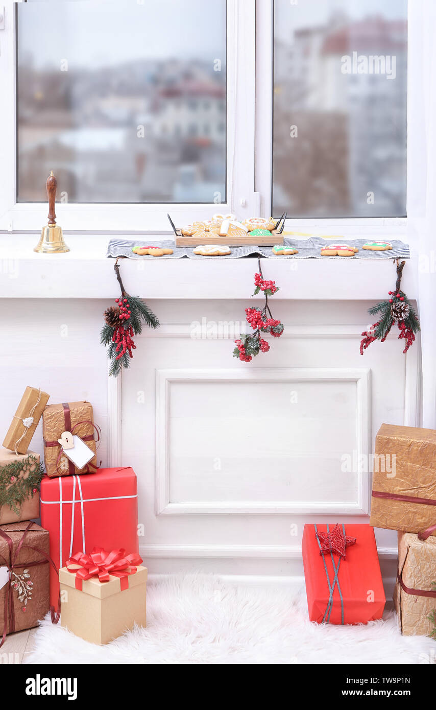Gift boxes and Christmas decorations near window at home Stock Photo ...