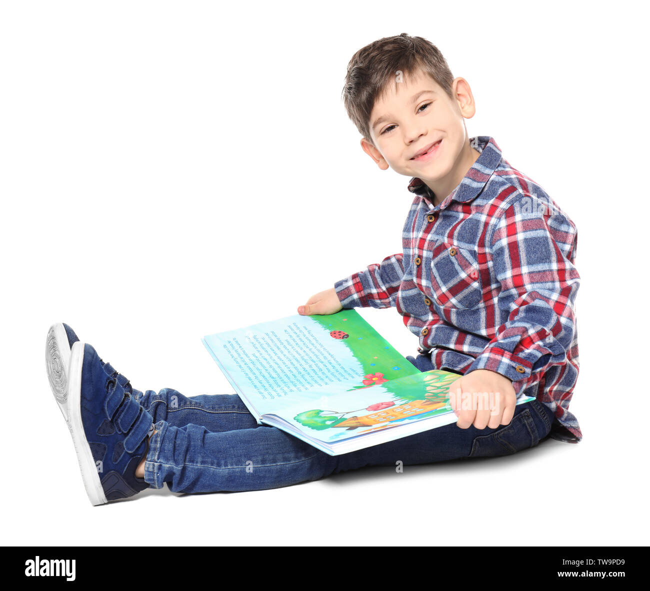 Cute little boy reading book on white background Stock Photo - Alamy
