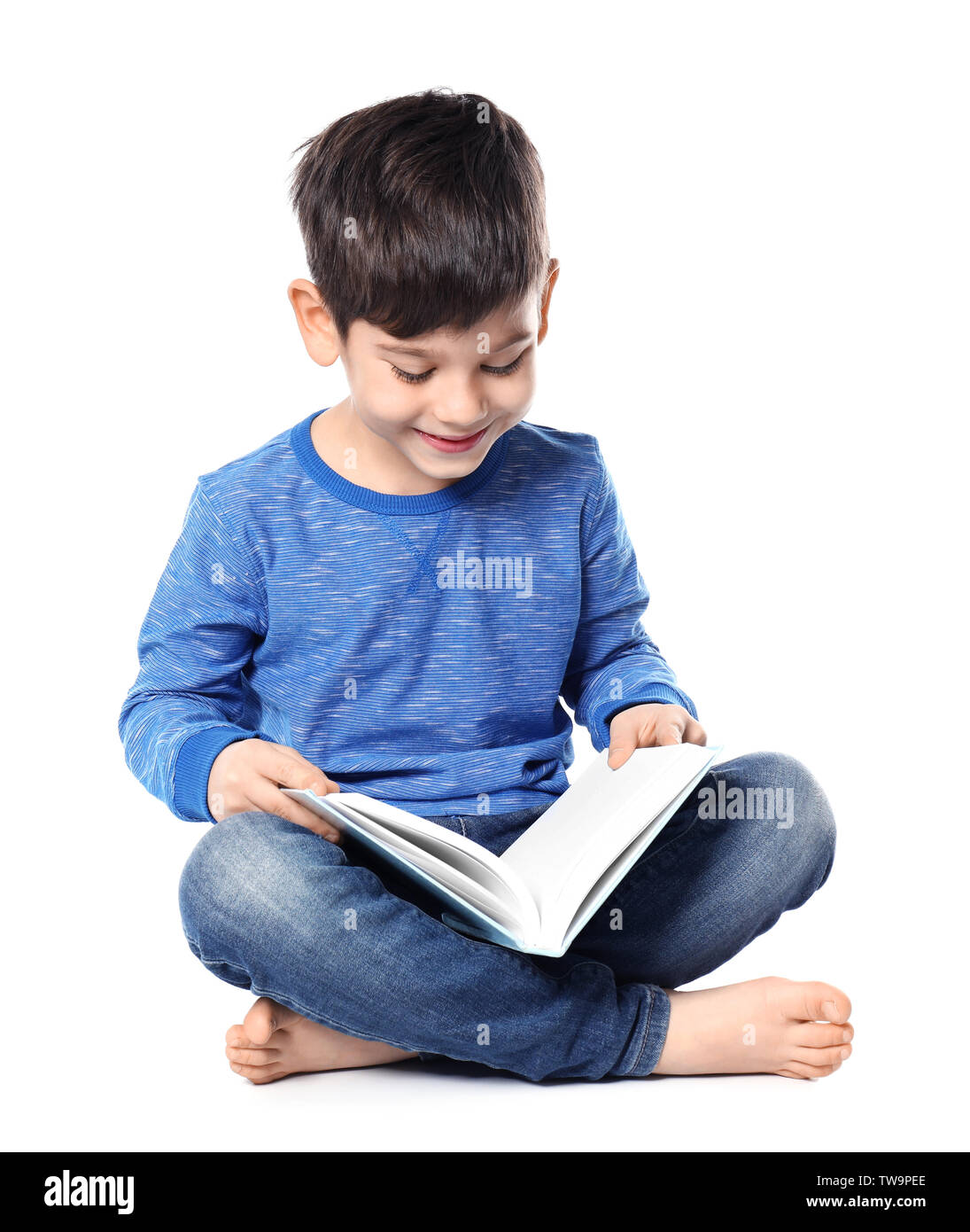 Cute little boy reading book on white background Stock Photo - Alamy