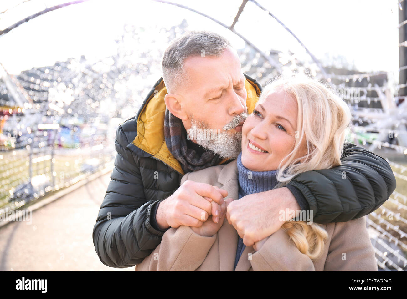 Happy mature couple hugging outdoors Stock Photo - Alamy