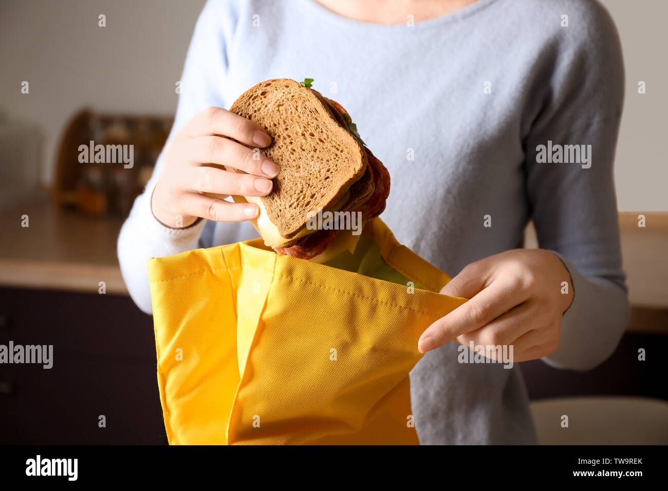 Mother packing food into school lunch bag indoors Stock Photo - Alamy